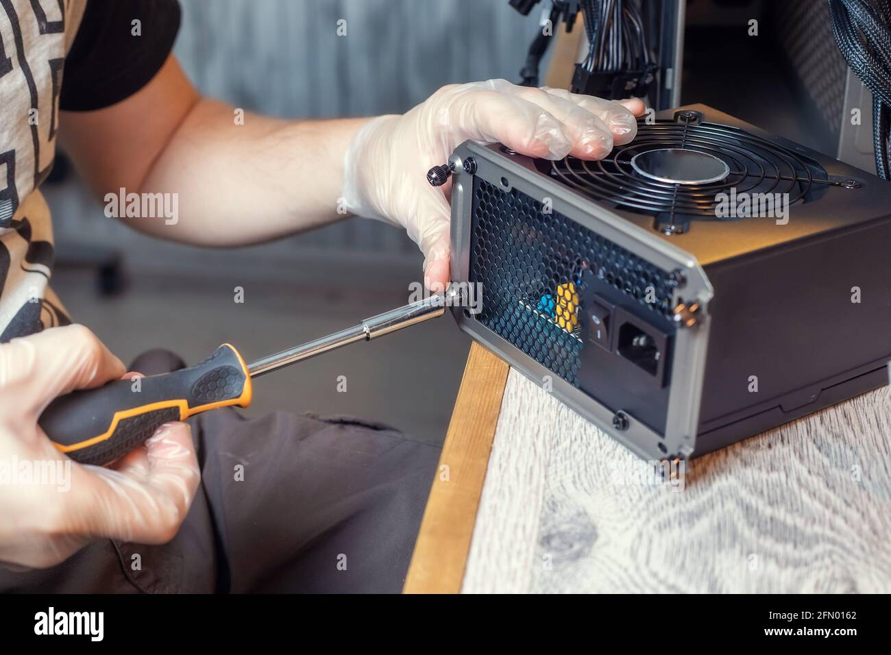 Installing Power Supply Unit into the desktop PC system unit. Computer ...