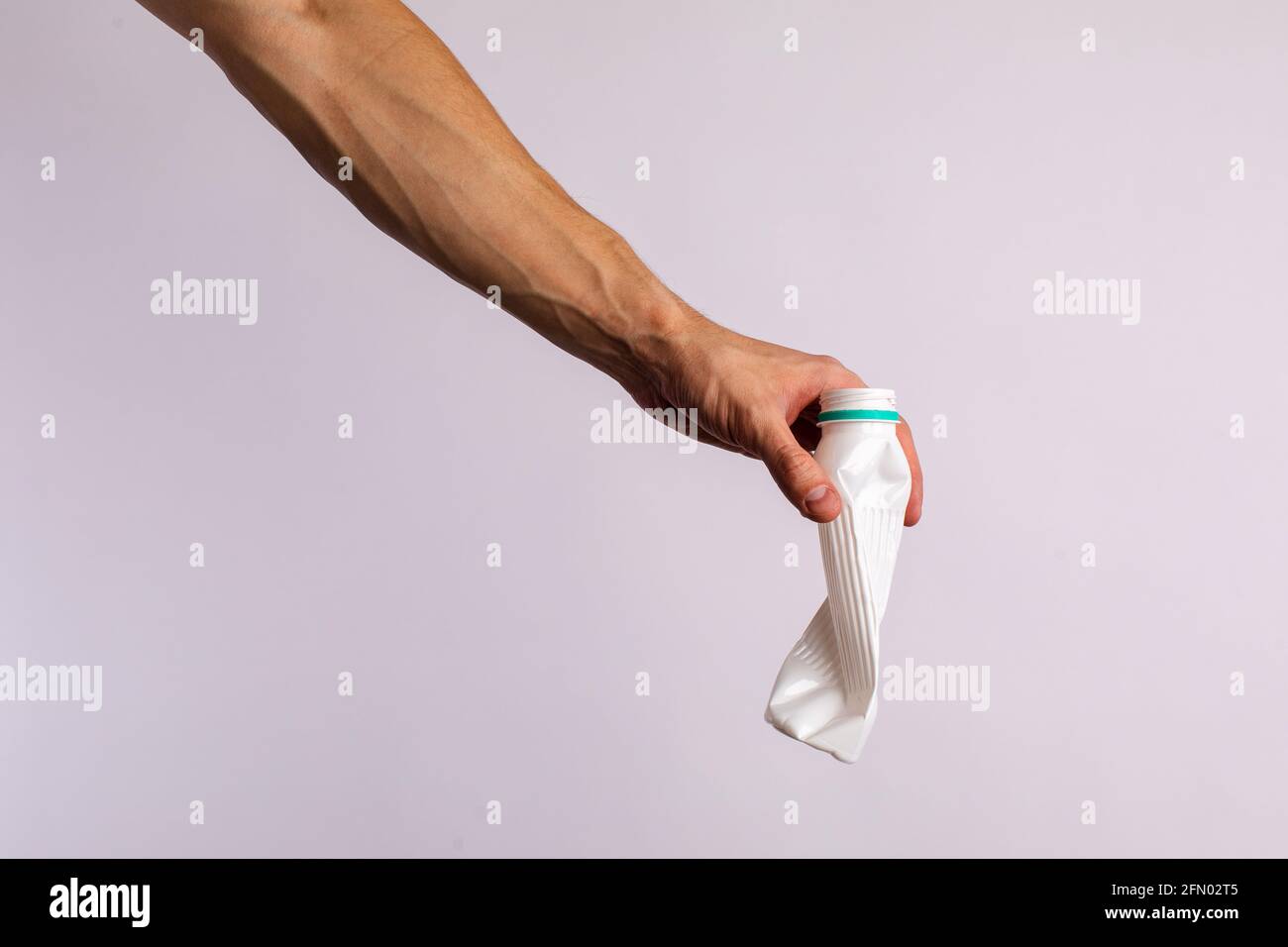 Hands hold trash on a light background. The concept of separate trash ...