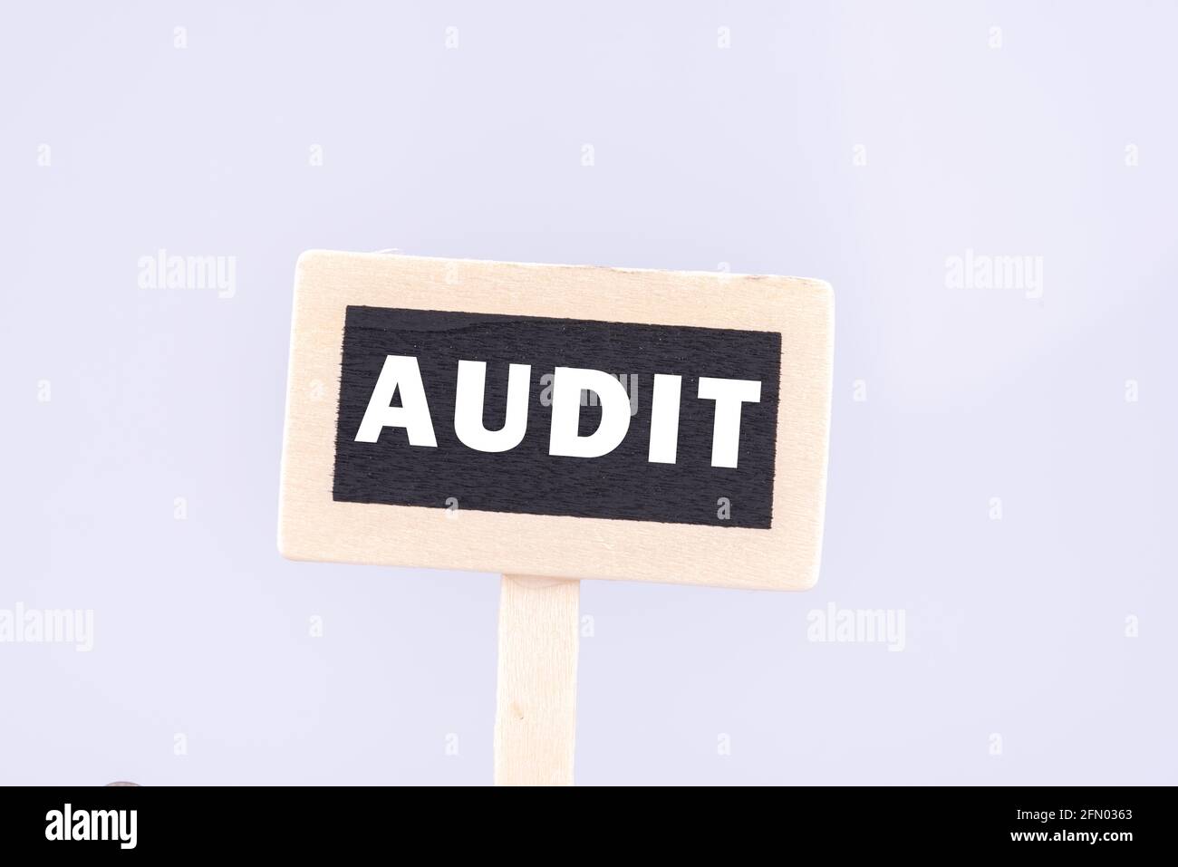 Closeup shot of a wooden Audit sign against a white background Stock ...