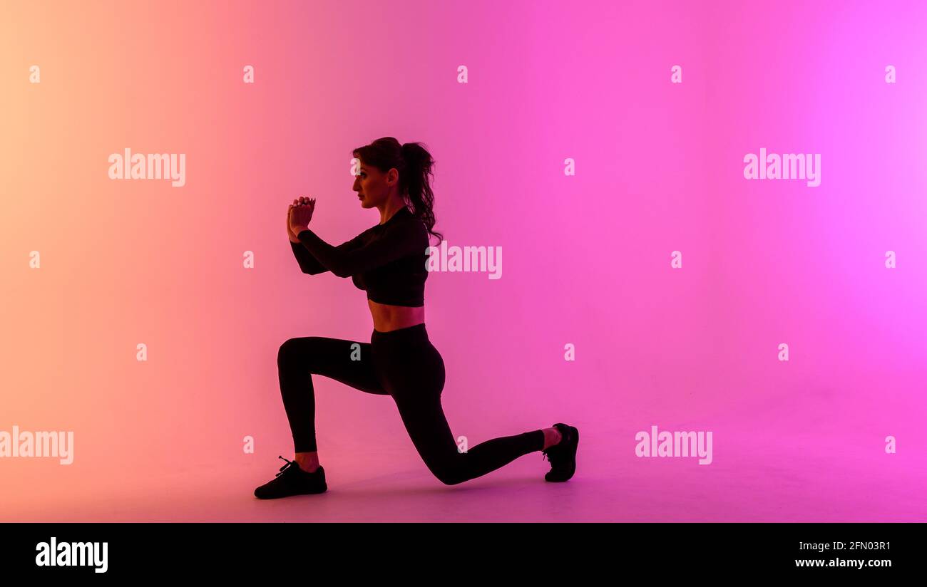Sports girl on a bright color background does exercises Stock Photo - Alamy