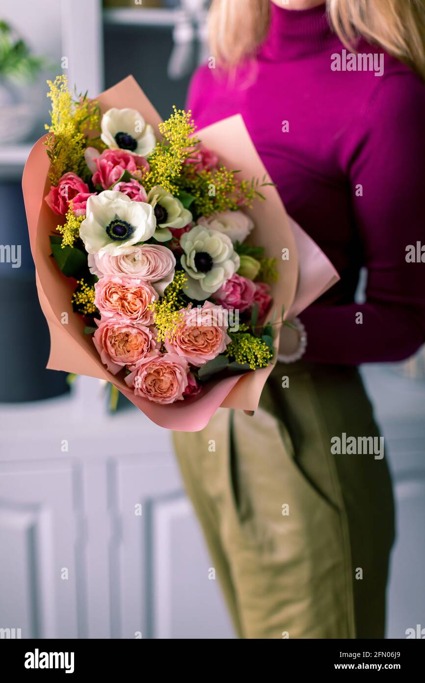 beautiful bouquet made of different flowers in young man hand ...