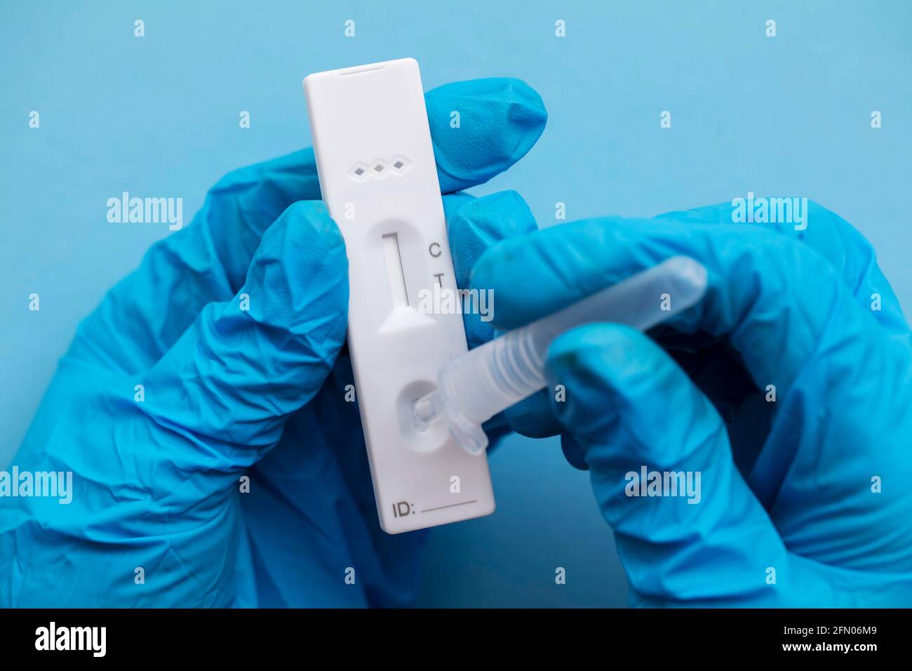 Close up of a person using coronavirus covid-19 rapid antigen home ...