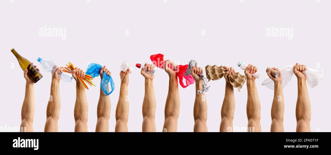 Hands hold trash on a light background. The concept of separate trash ...