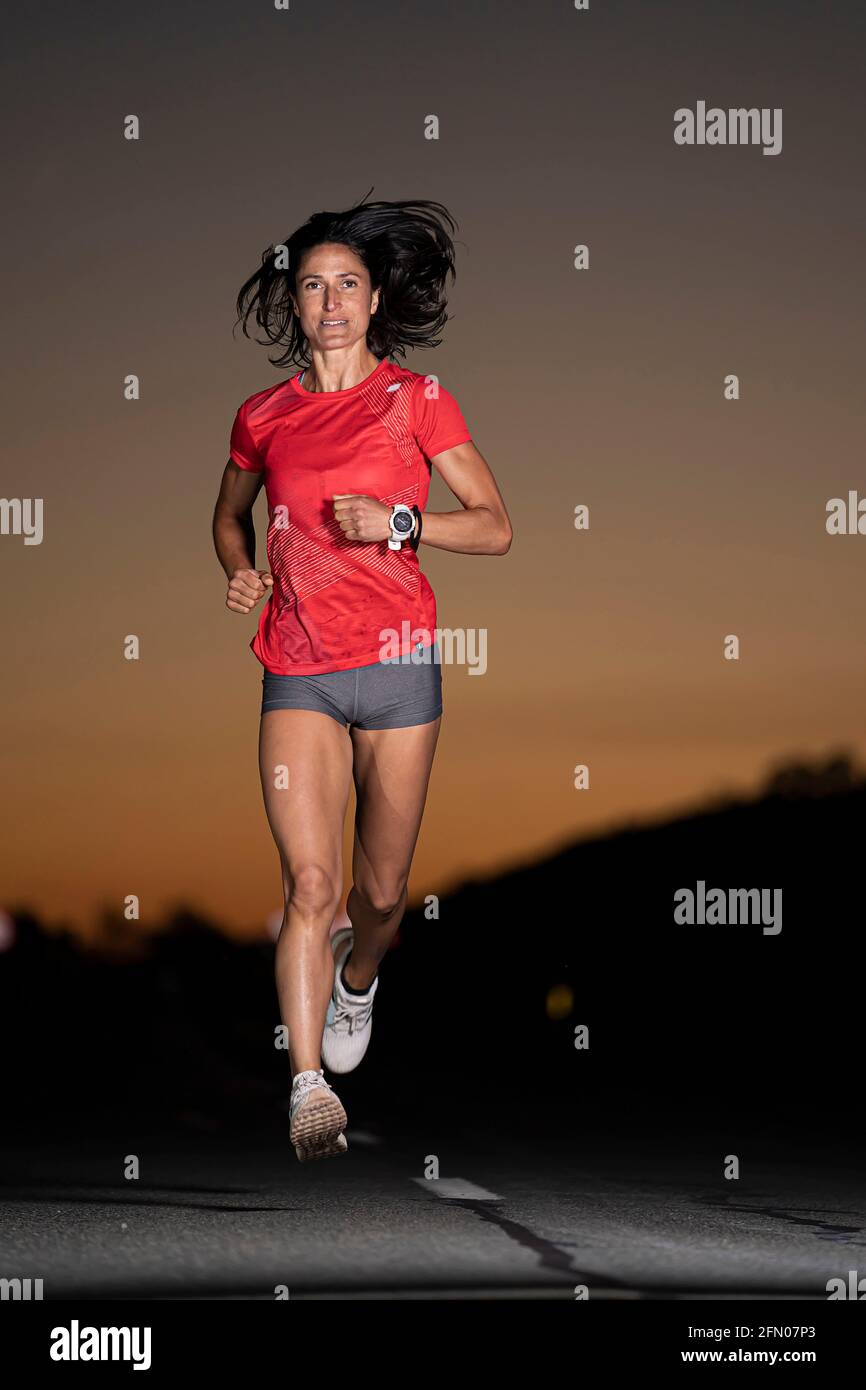 Girl running in nature and with sunset, it is her free and healthy ...
