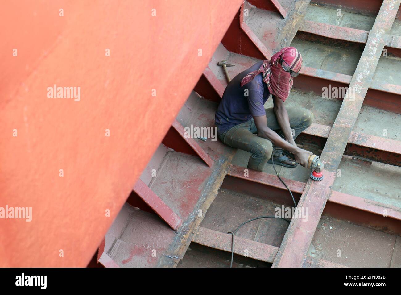 a boat restoration worker with machine and equipment Stock Photo - Alamy