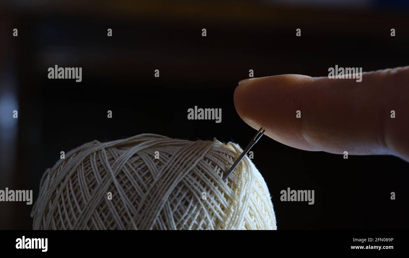 Needle and yellow thread with black background Close up Needle and ...