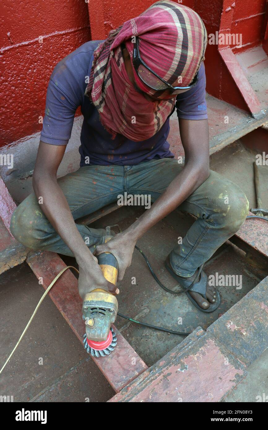a boat restoration worker with machine and equipment Stock Photo - Alamy