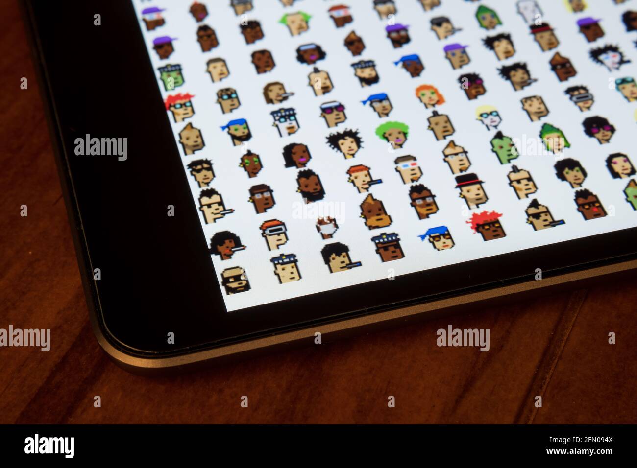 CryptoPunks NFT characters seen on the screen of tablet. One of the ...