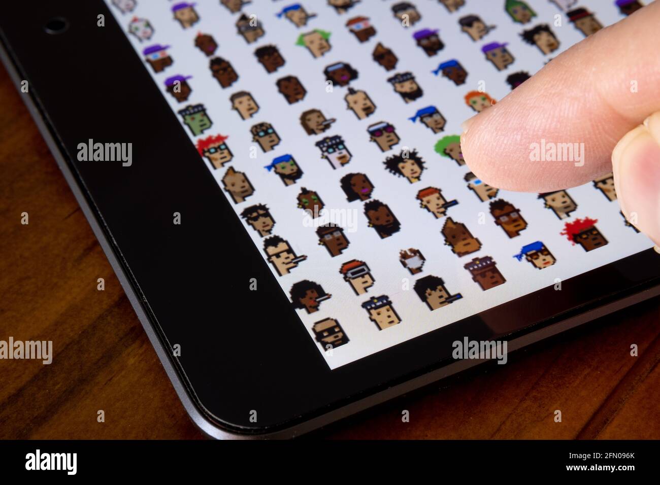 CryptoPunks NFT characters seen on the screen of tablet. One of the ...
