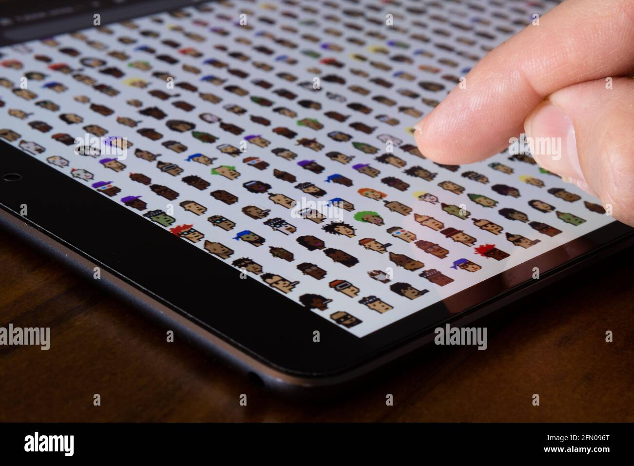 CryptoPunks NFT characters seen on the screen of tablet. One of the ...