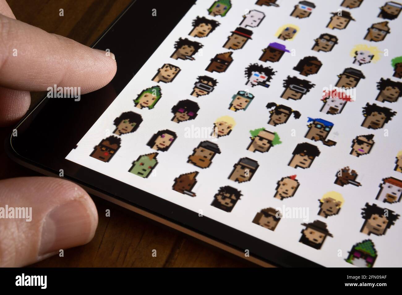 CryptoPunks NFT characters seen on the screen of tablet. One of the ...