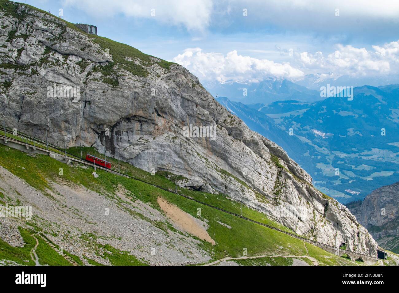 landscape in the Alps One red train carriage at the side of the ...