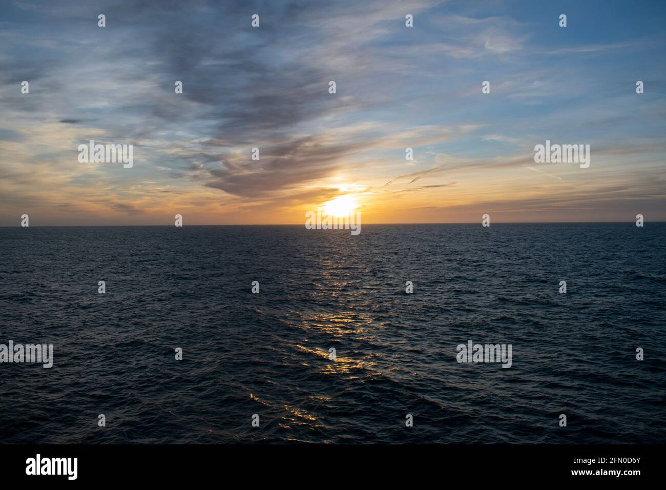 Sunset at the beach of the Hague with clouds sun in center -Den Haag ...