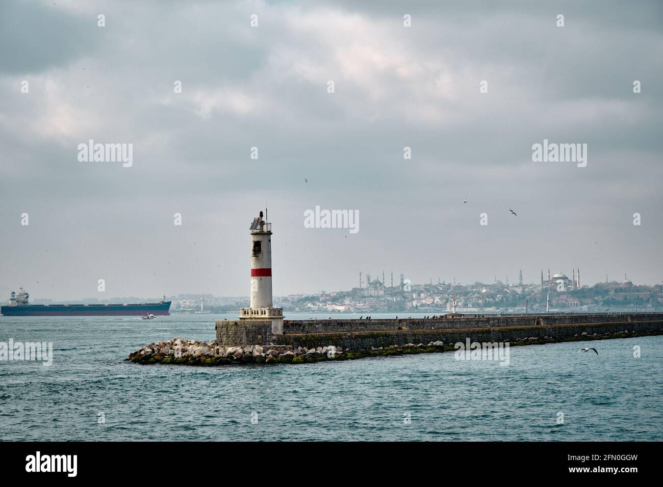 Lighthouse in bosporus with silhouette of grand ottoman mosques Hagia ...
