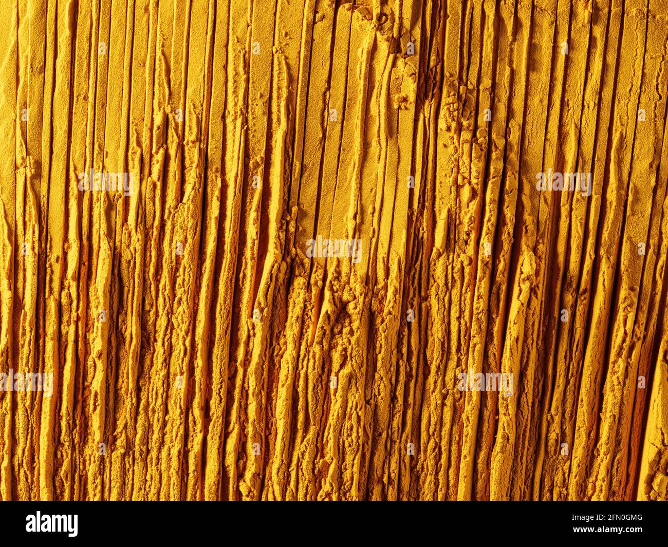 Yellow powder of grated turmeric with texture, food background. View ...