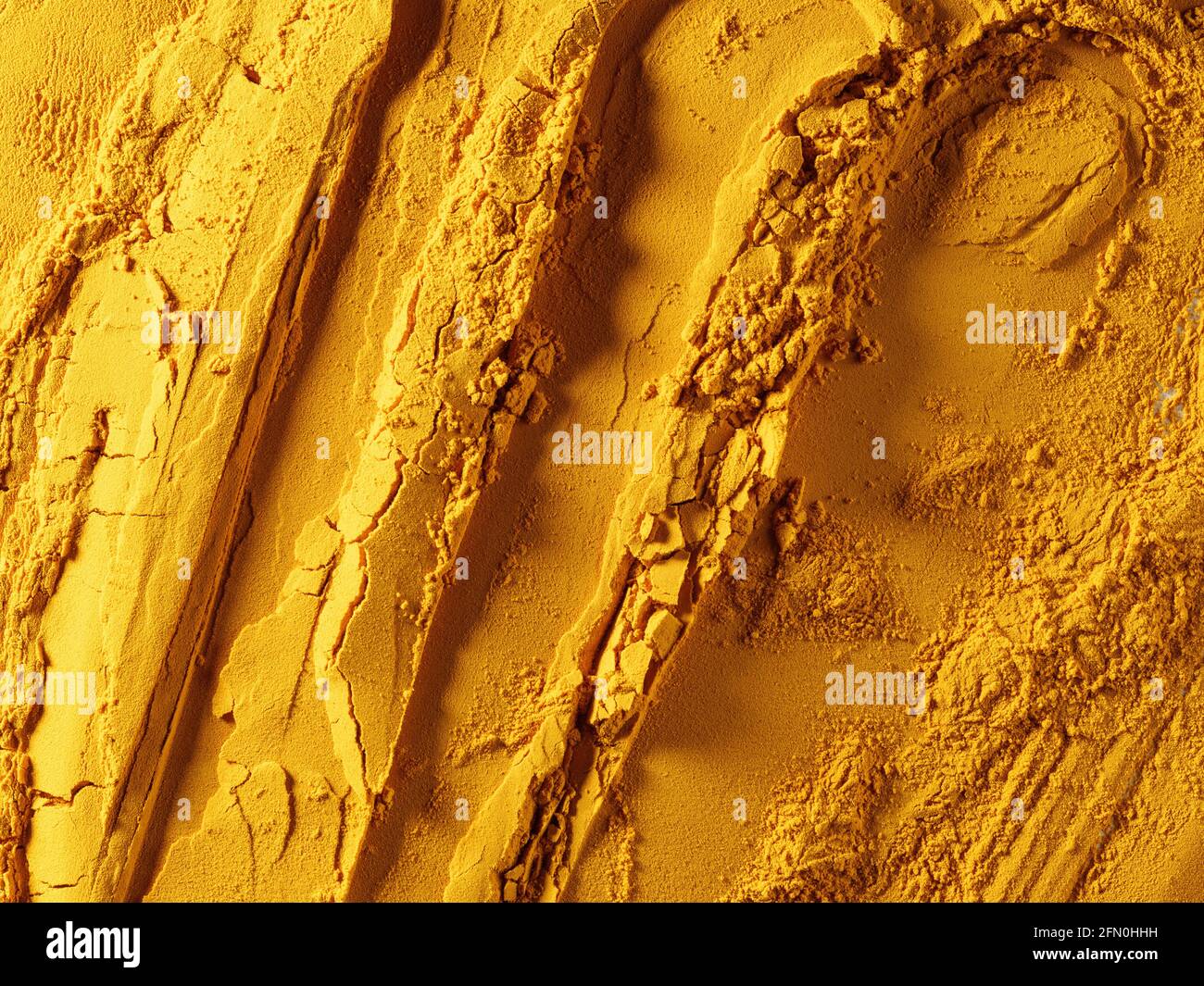 Yellow powder of grated turmeric with texture, food background. View ...