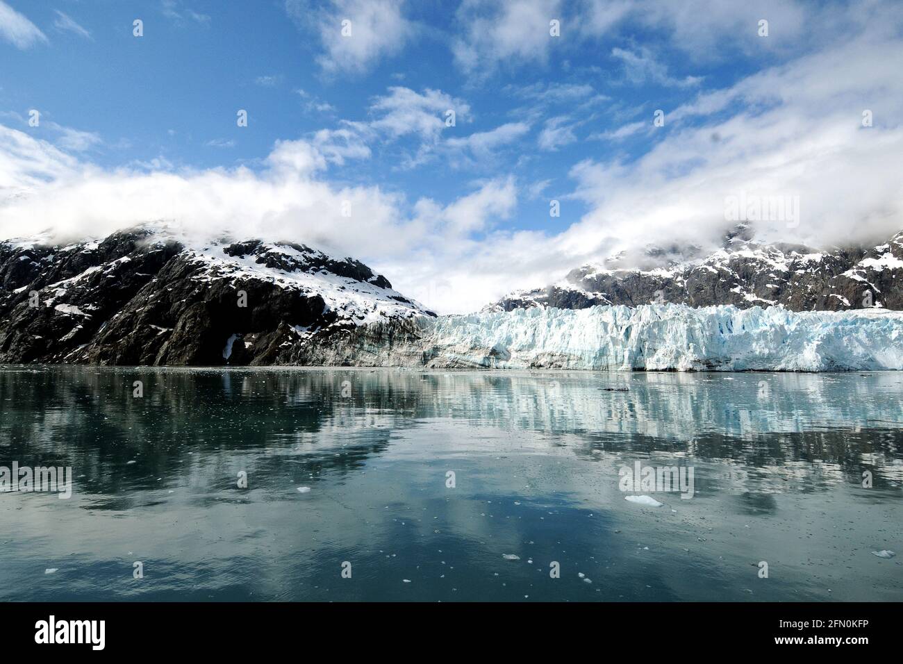 Glacier and mountain reflecting in calm water of Glacier Bay, Alaska ...