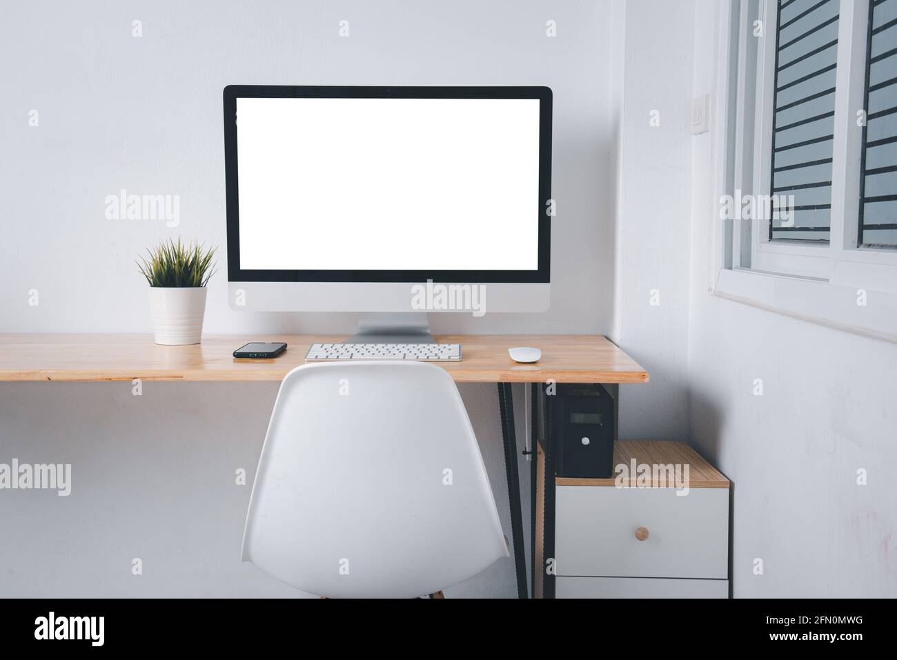 Computer monitor with white blank screen on the business desk with ...
