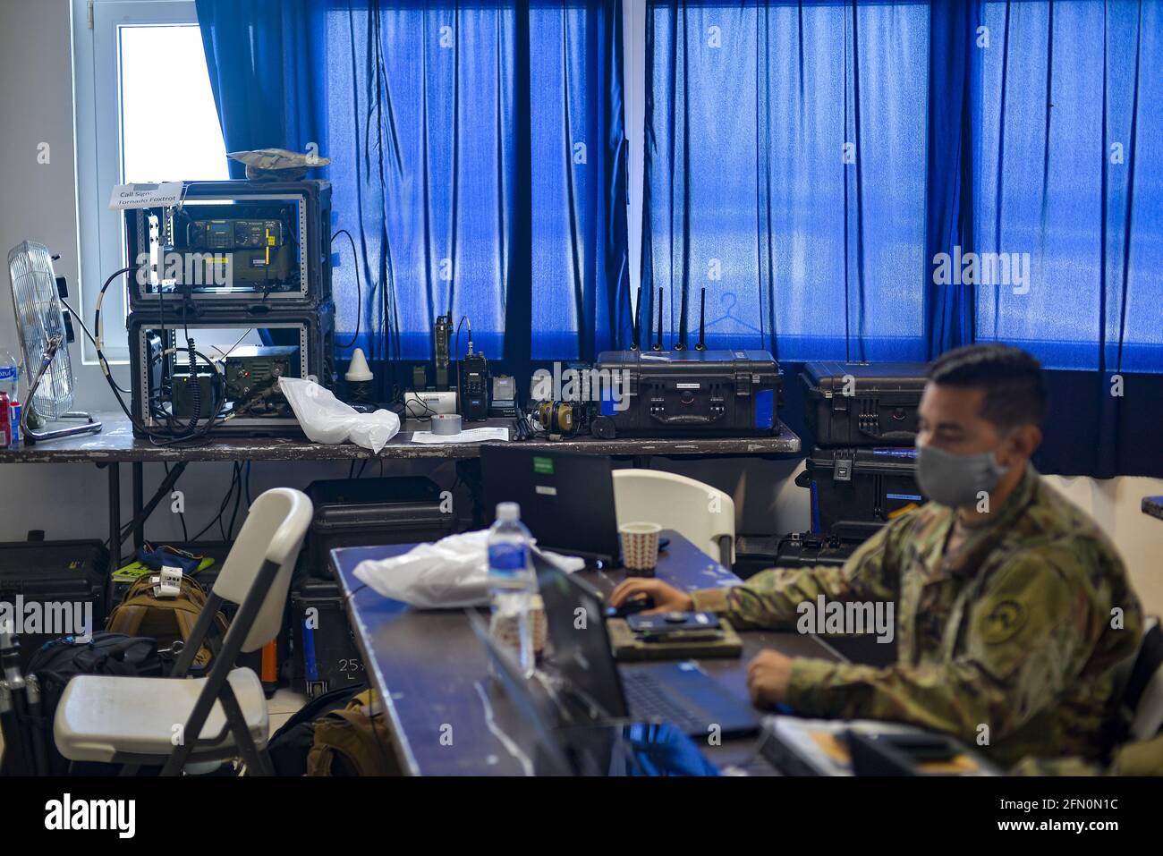 A US army communications specialist sets up a satellite transmission ...