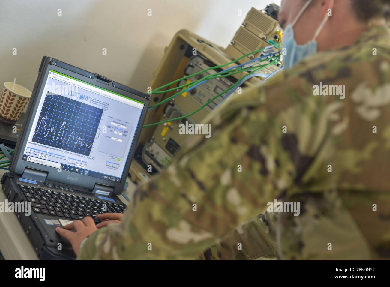 A US army communications specialist sets up a satellite transmission ...