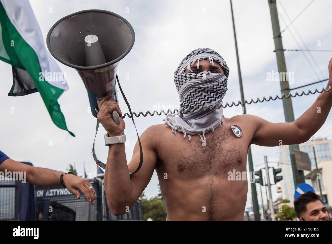 Athens, Greece. 12th May, 2021. A protester holds a megaphone during ...