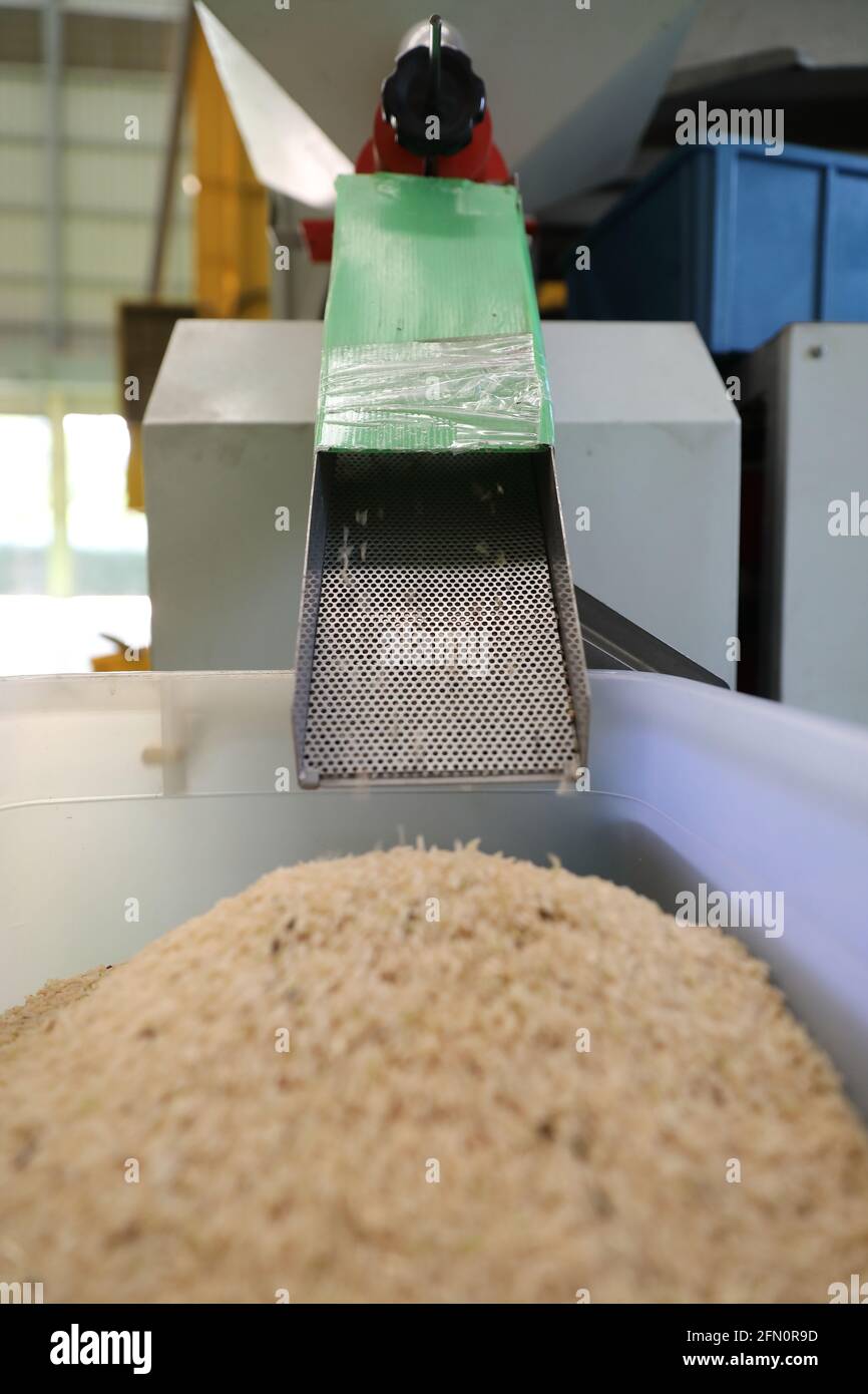 Factory machine Milling rice in close up Stock Photo - Alamy