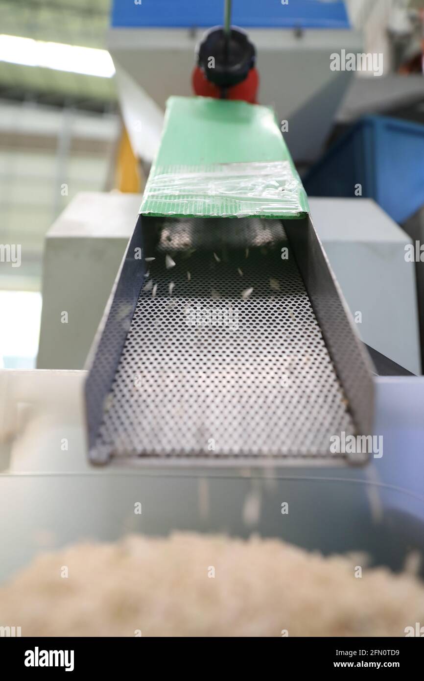 Factory machine Milling rice in close up Stock Photo - Alamy