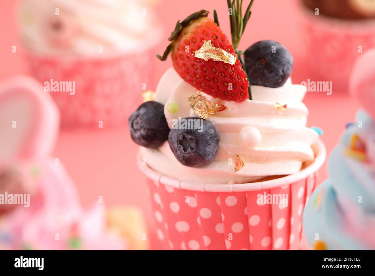 Colorful cupcakes isolated in pink background Stock Photo - Alamy