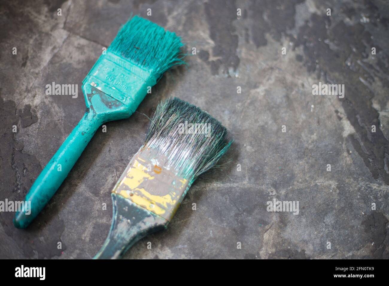 High angle shot of old dirty paint brushes on a concrete surface Stock Photo - Alamy