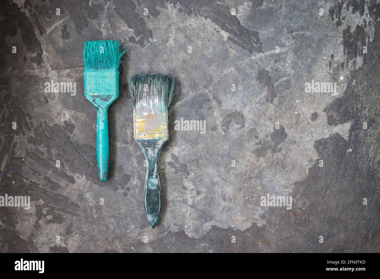 Top view of old dirty paint brushes on a concrete surface Stock Photo - Alamy