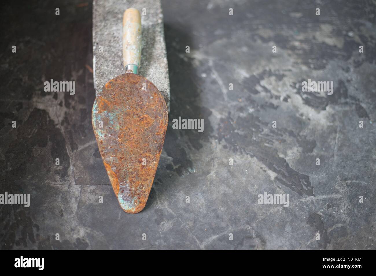 High angle shot of an old rusty trowel on a concrete surface Stock ...