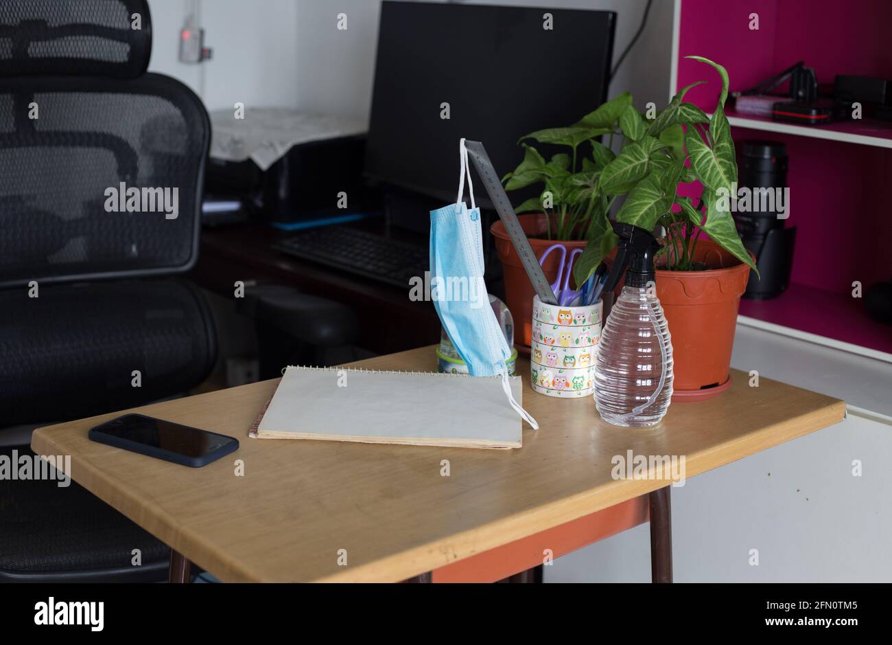 View of an office desk with a face mask Stock Photo - Alamy