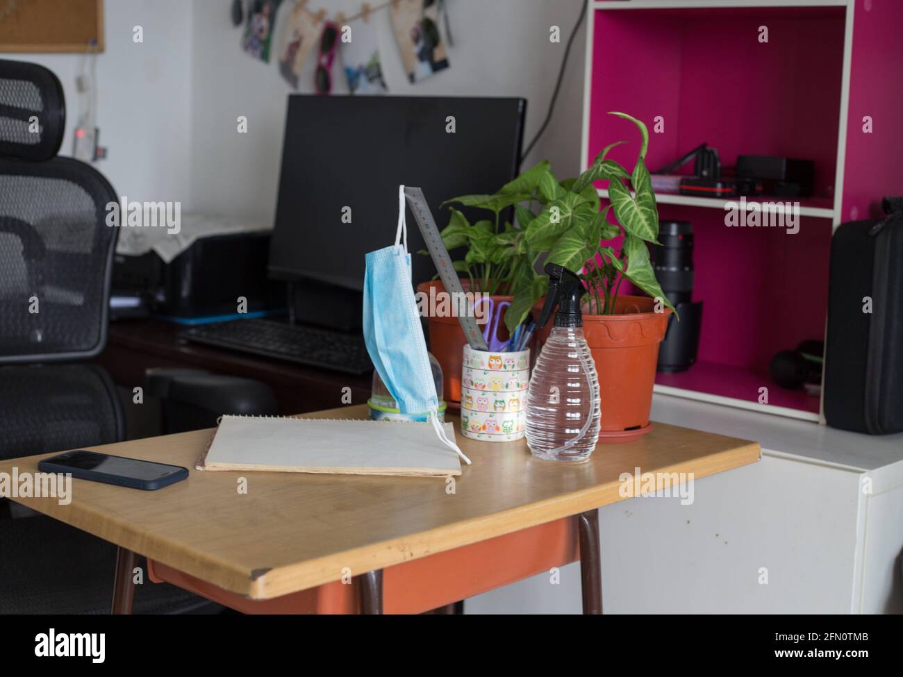 View of an office desk with a face mask Stock Photo - Alamy