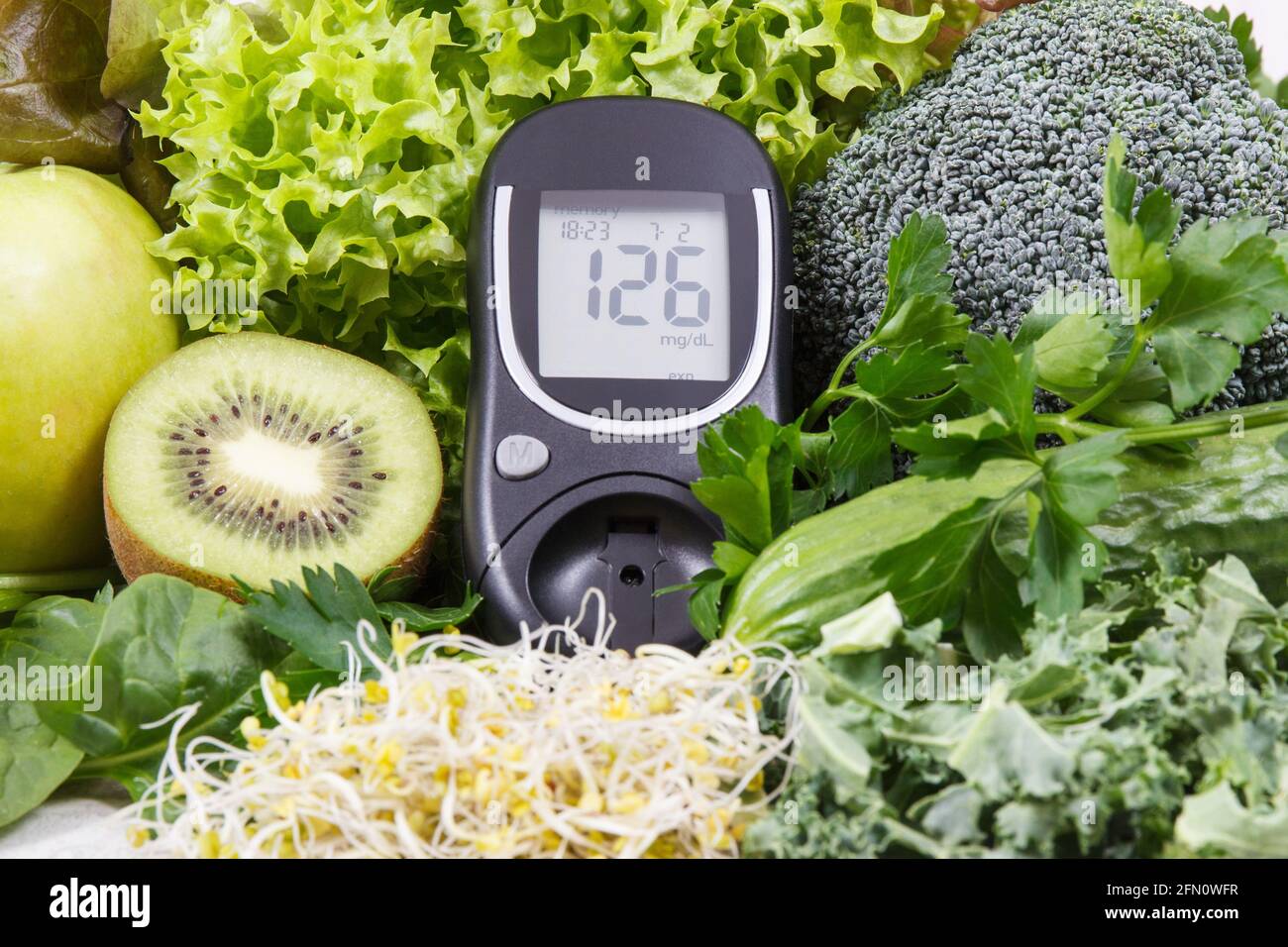 Glucometer for measuring sugar level and vegetables with sprouts as ...