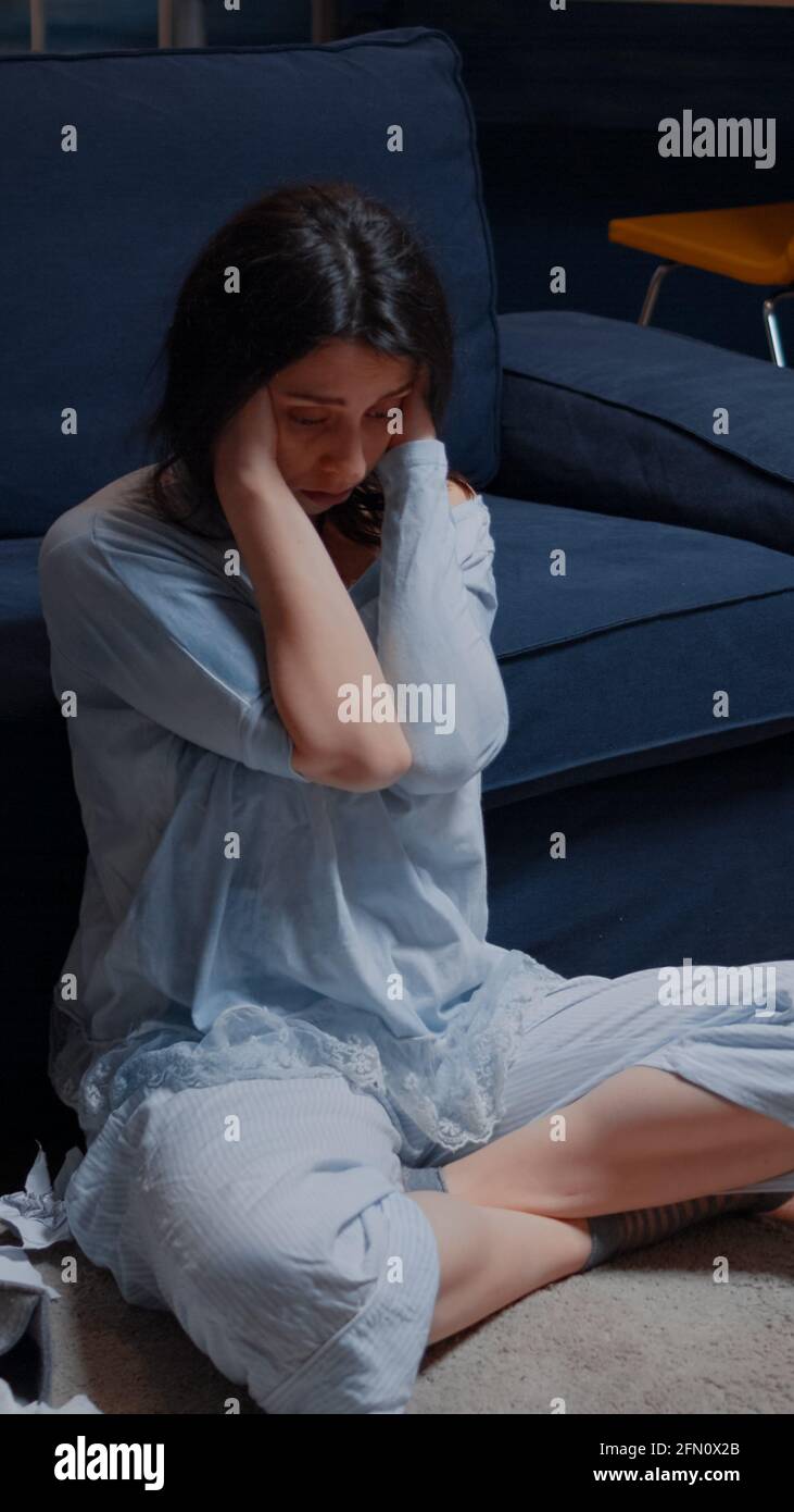 Sad hopeless young woman sitting alone at home feeling desperate ...