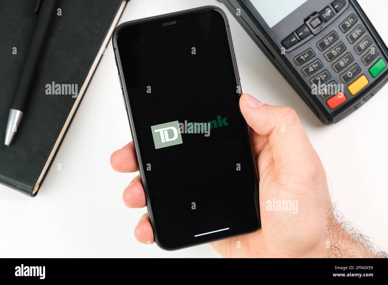 TD bank logo on the black smartphone screen in mans hand on the ...