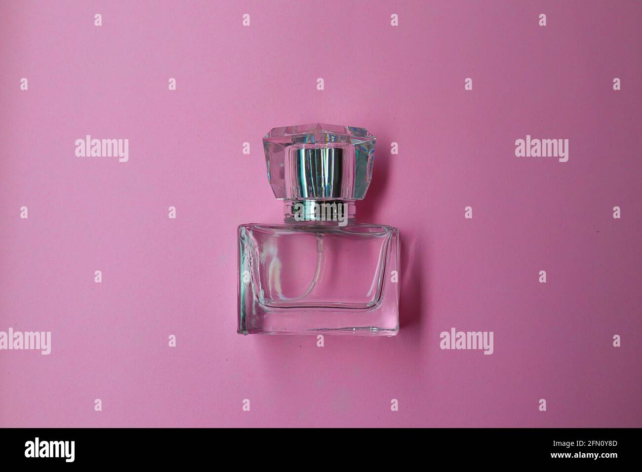 perfume on pink background Stock Photo - Alamy