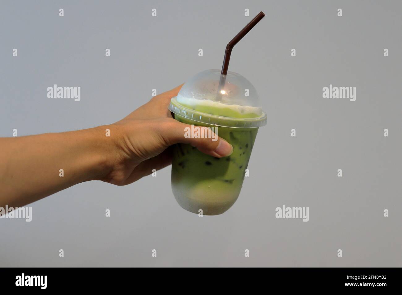 hand holding a glass of green tea Stock Photo - Alamy
