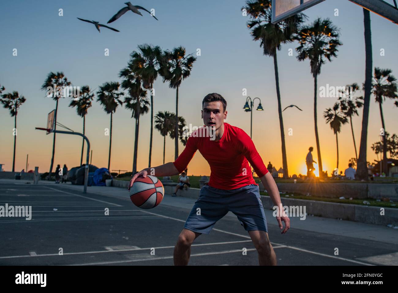 Basketball player training basketball on a court in Venice Beach Stock ...