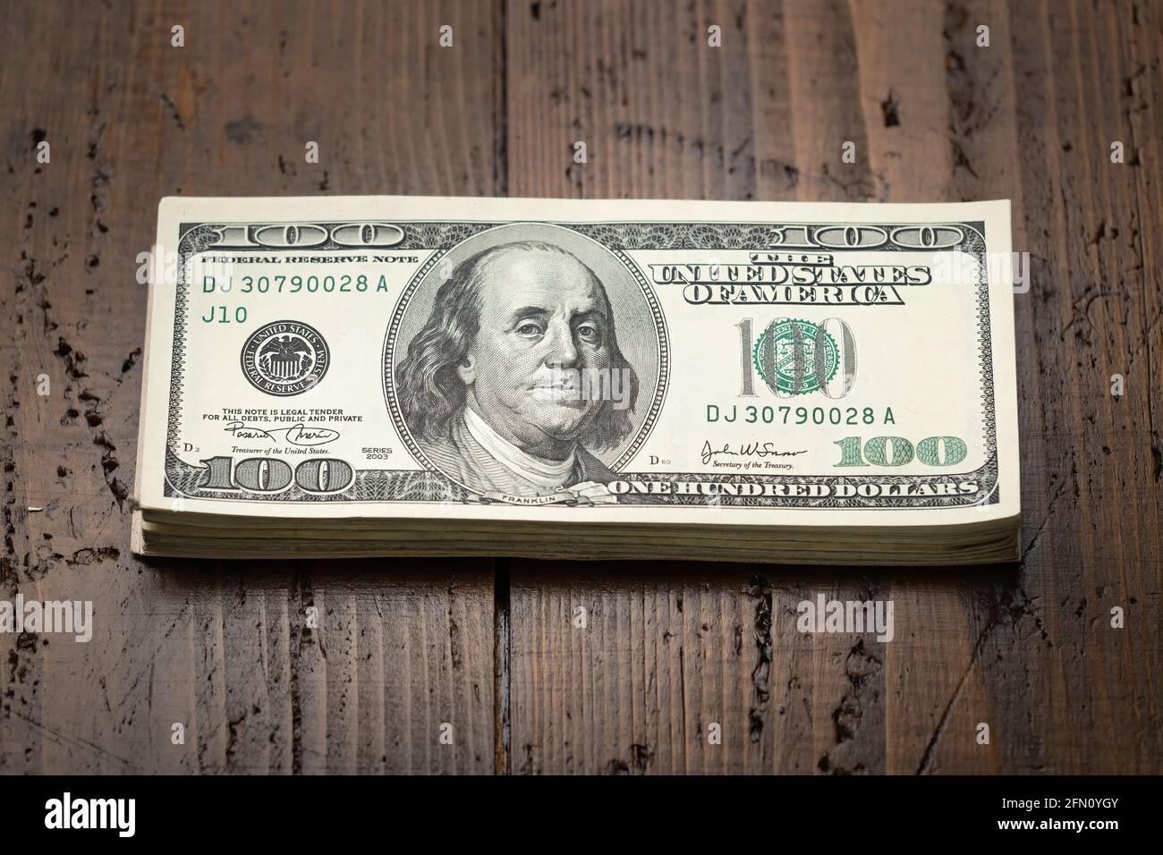 A money pile of stacked one hundred US banknotes with president ...