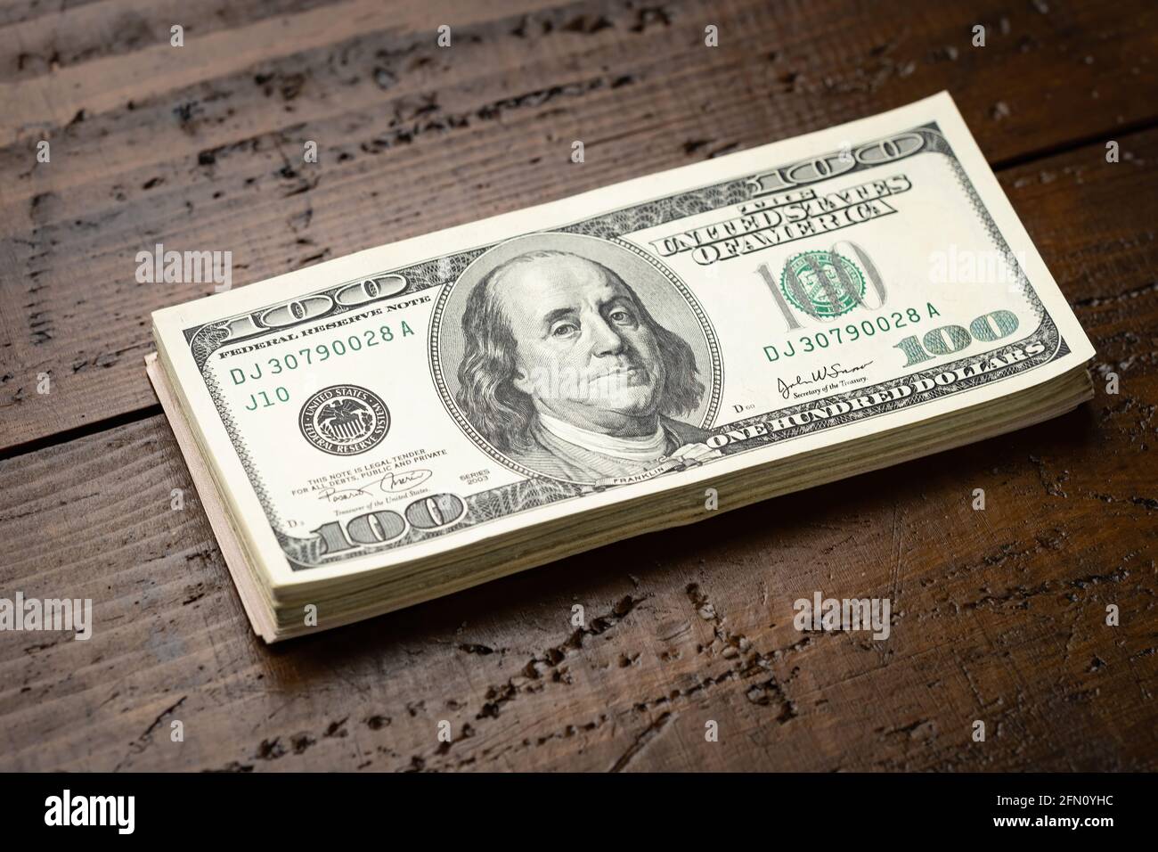 A money pile of stacked one hundred US banknotes with president ...