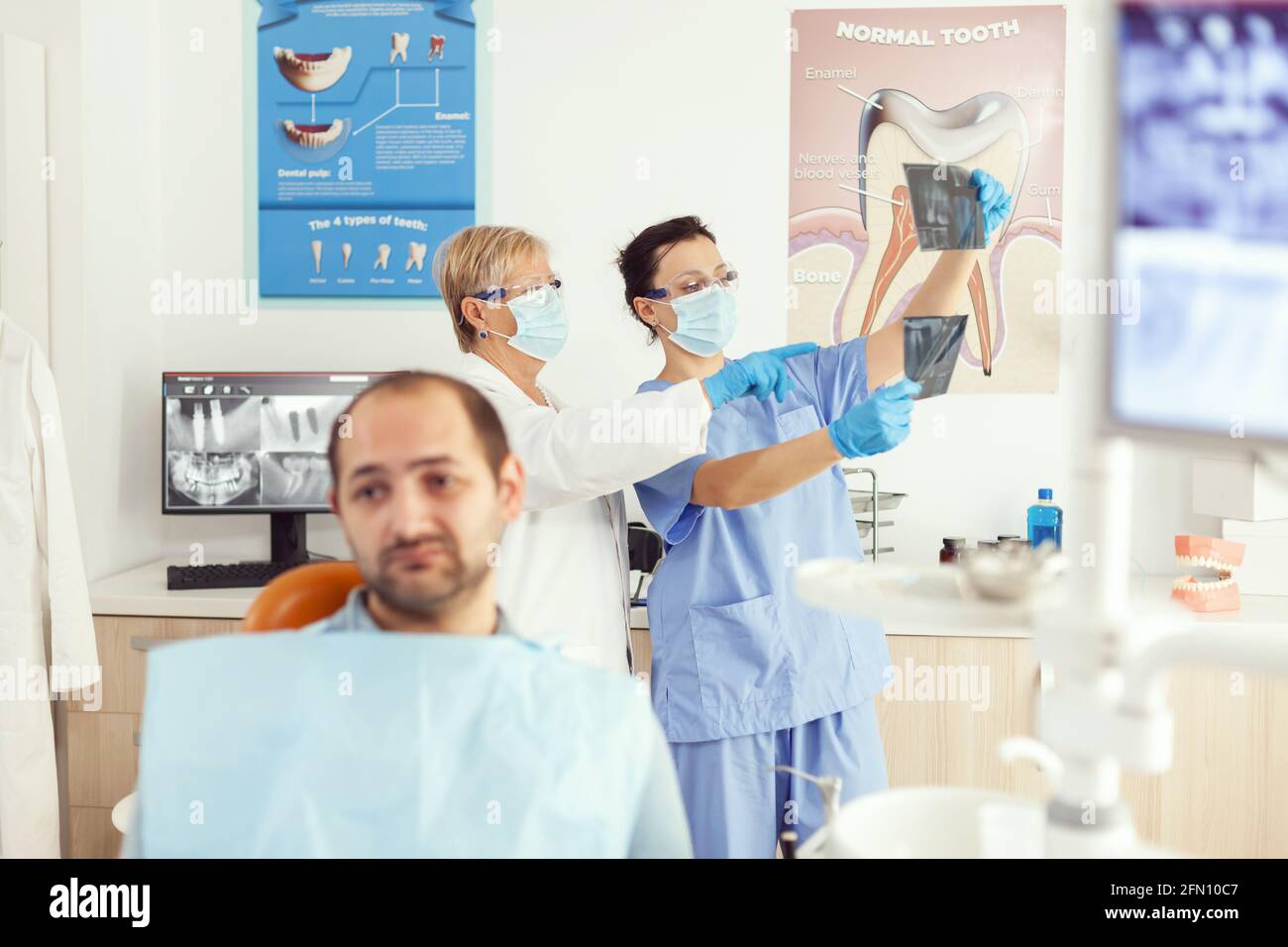 Sick man patient waiting for teeth examination sitting on dental chair ...