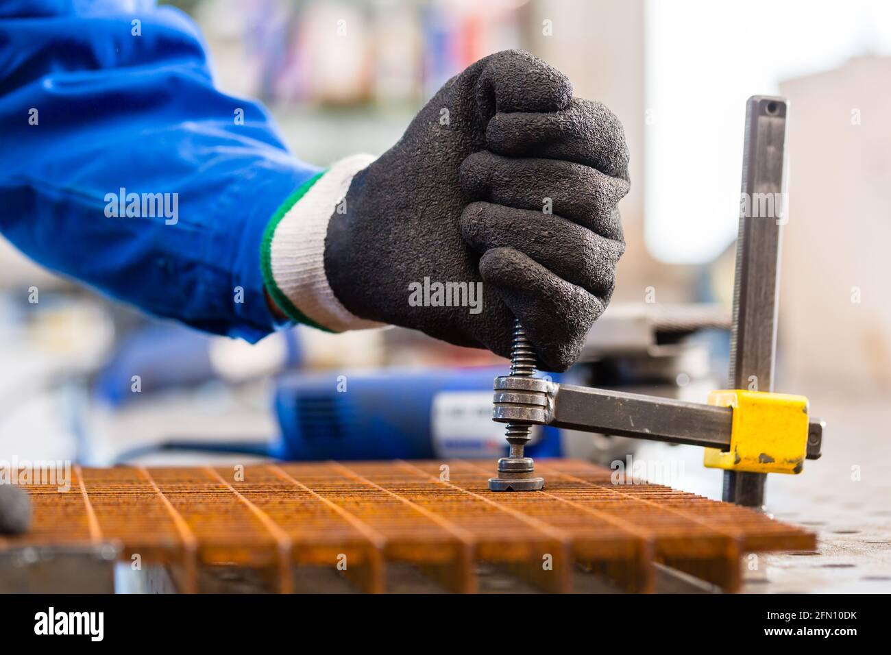 Craftsman clamping metal with workbench clamp in workshop Stock Photo ...