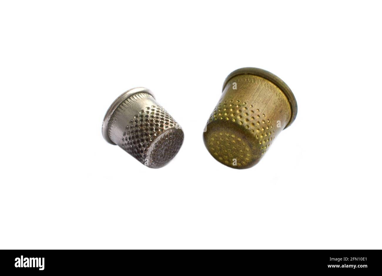 Two vintage thimbles isolated on a white background Stock Photo - Alamy