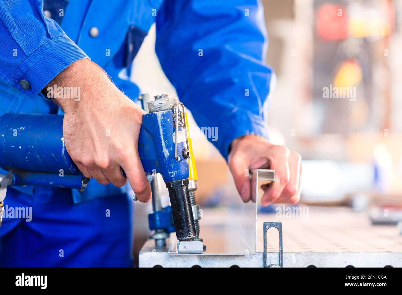 Craftsman rivet metal with air compressed pistol in workshop Stock ...