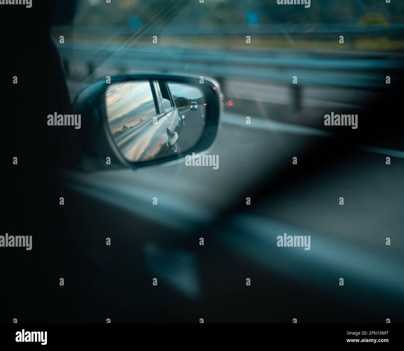 Car side mirror view in the highway. fast-moving automobile concept ...