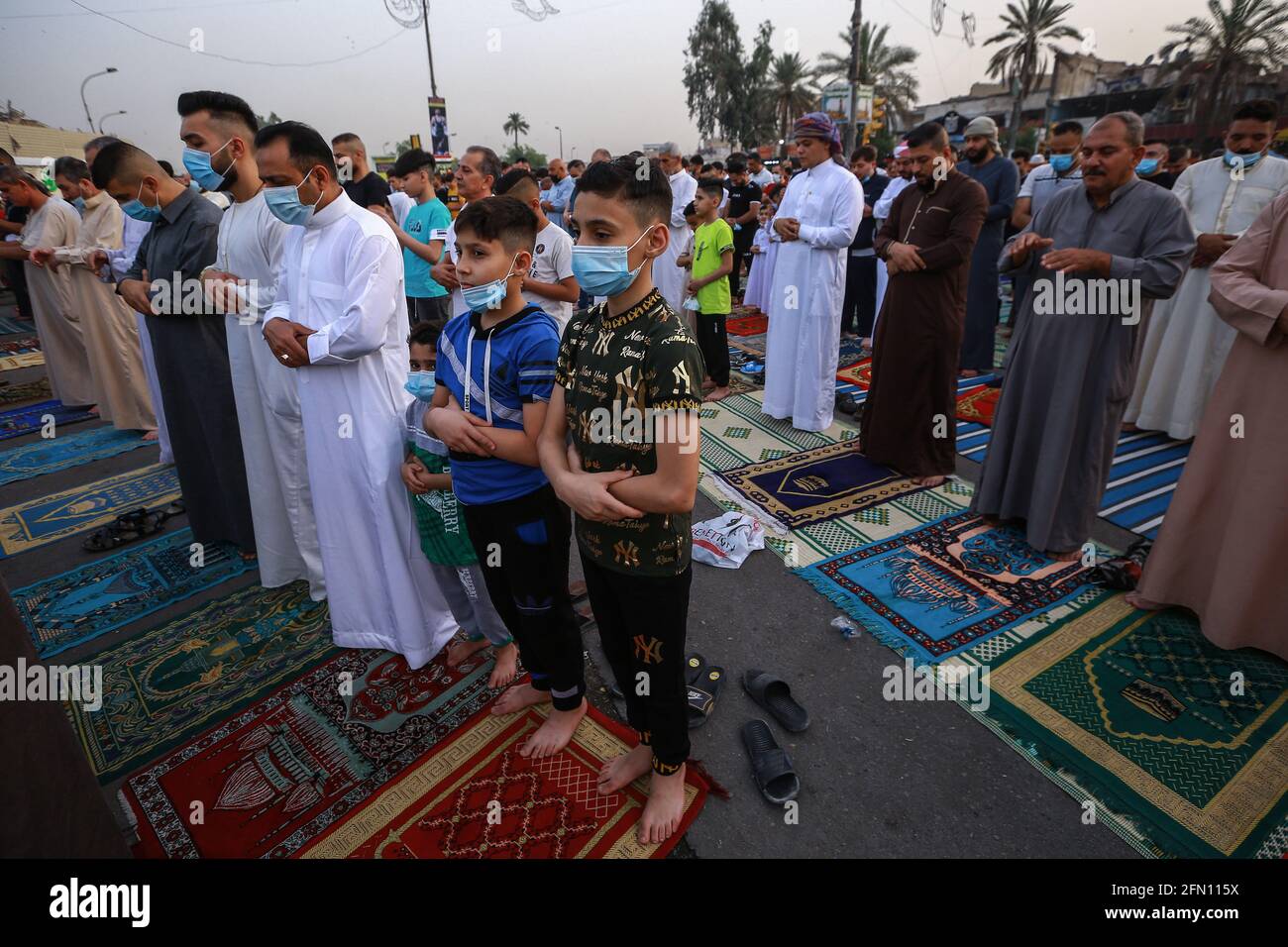 Baghdad, Iraq. 13th May, 2021. Worshippers perform Eid al-Fitr prayer ...