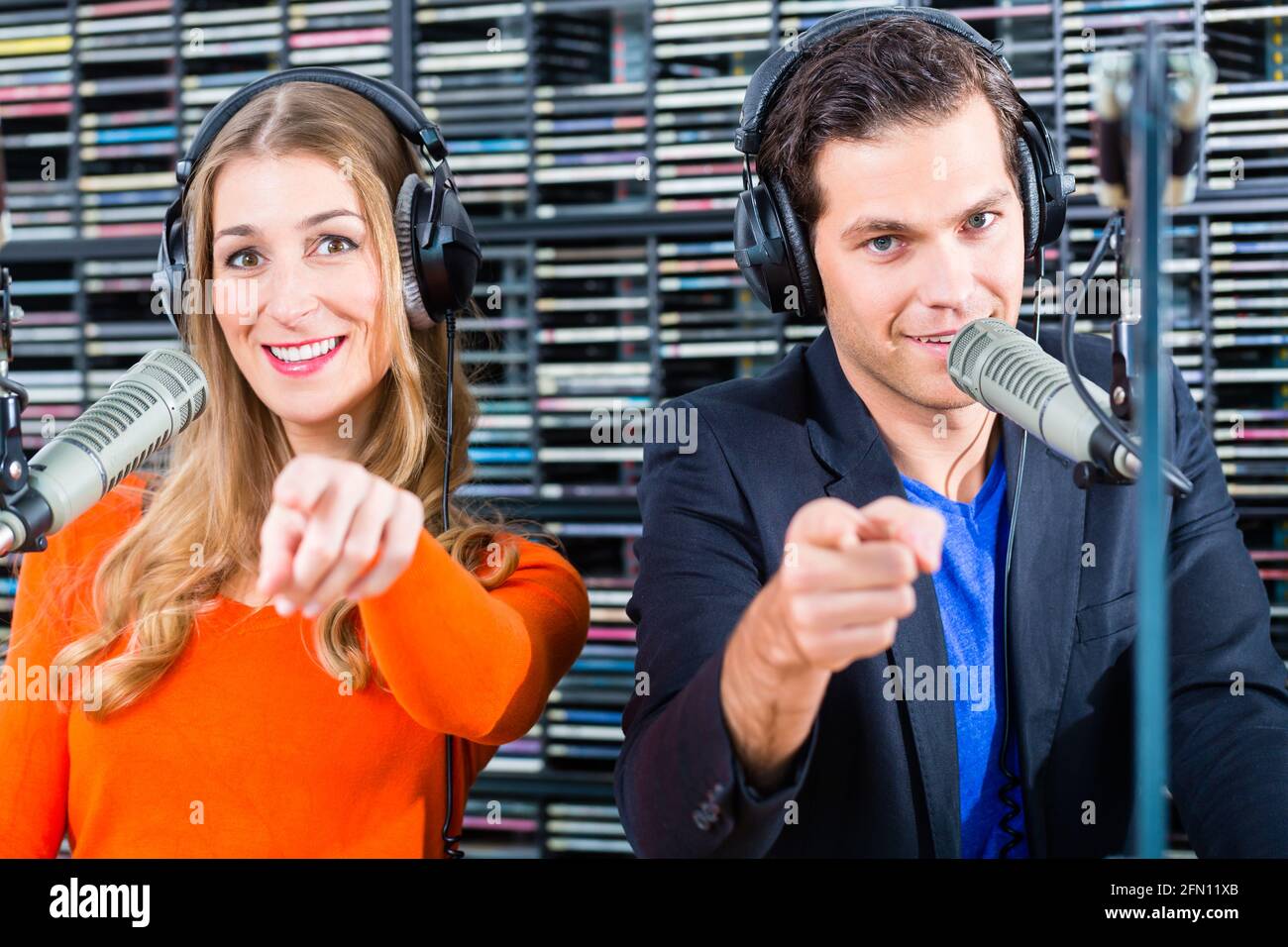 Presenters or moderators - man and woman - in radio station hosting ...