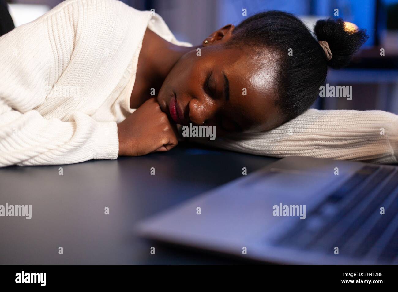 Exhausted overload african business woman falling asleep on desk with ...