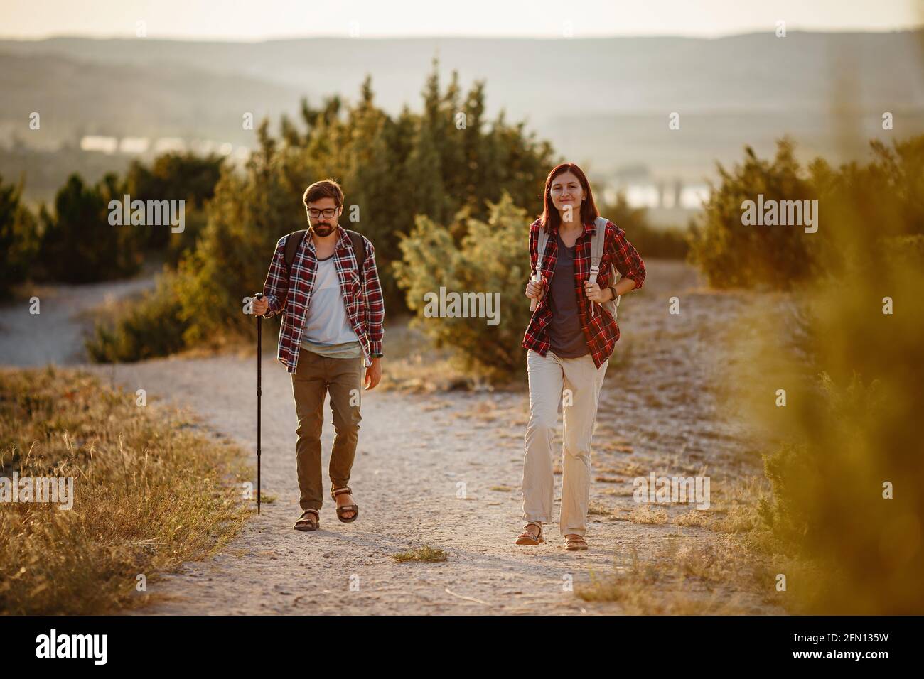 Portrait of happy young couple having fun on their hiking trip ...